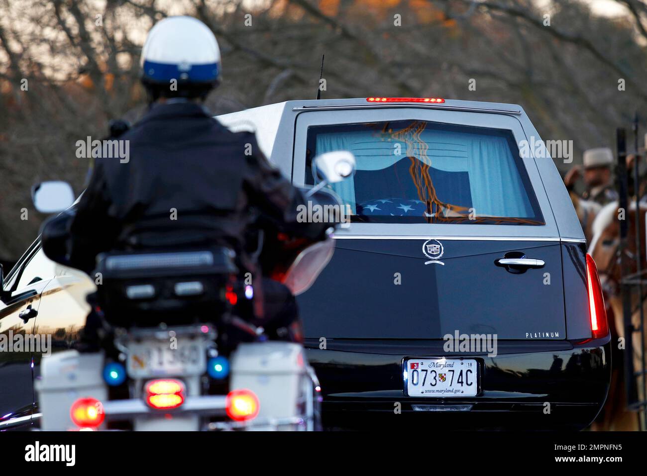 A hearse carrying Baltimore Police Det. Sean Suiter's flag-draped ...