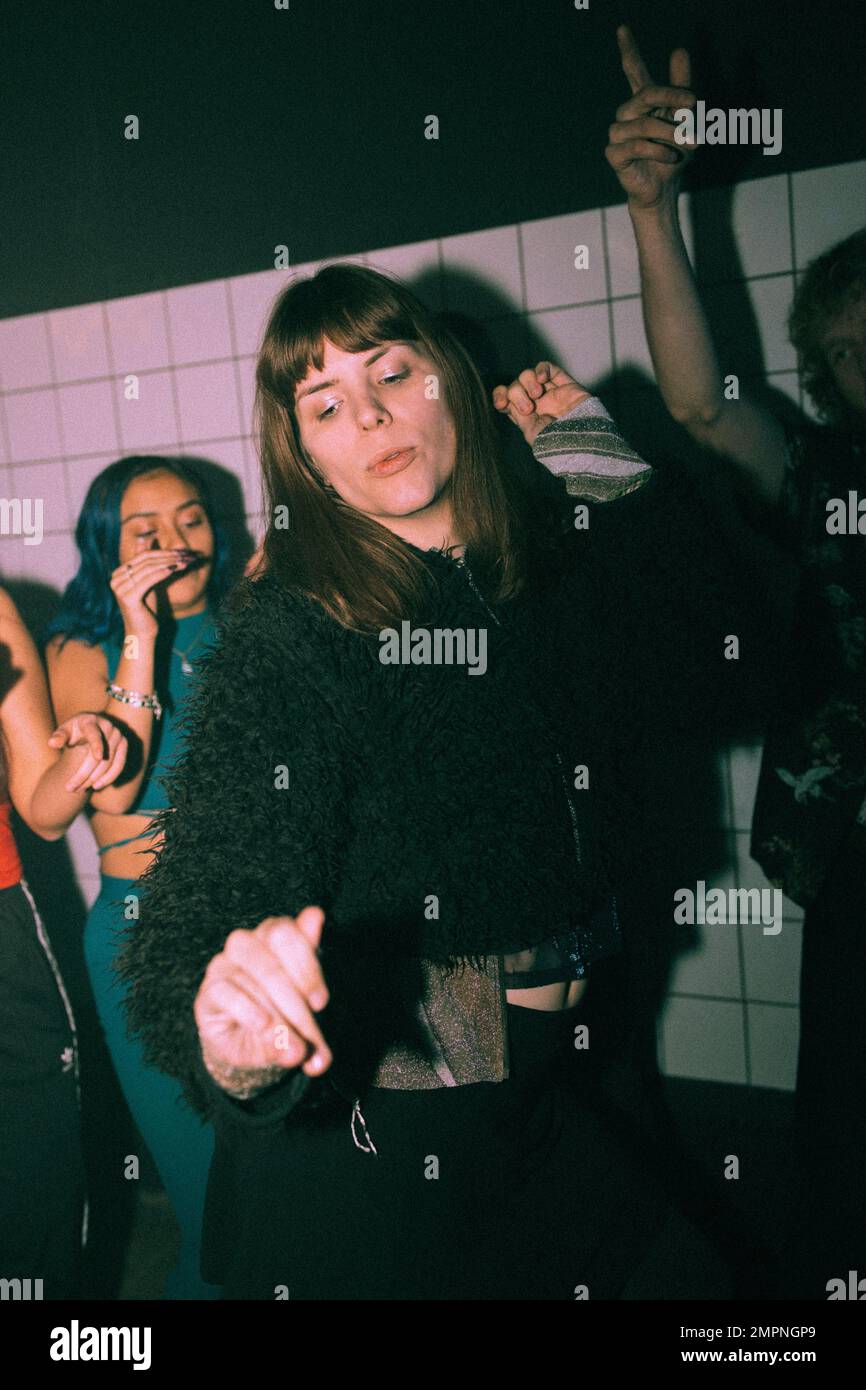 Transgender woman dancing against friends at nightclub Stock Photo - Alamy