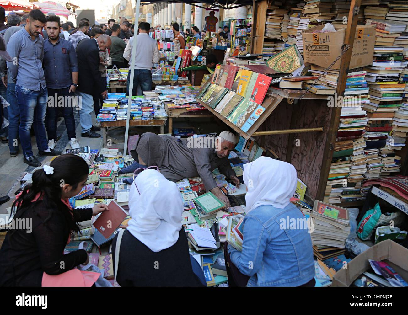 In this, Friday, Nov. 24, 2017, Iraqis shop for books on al-Mutanabi ...