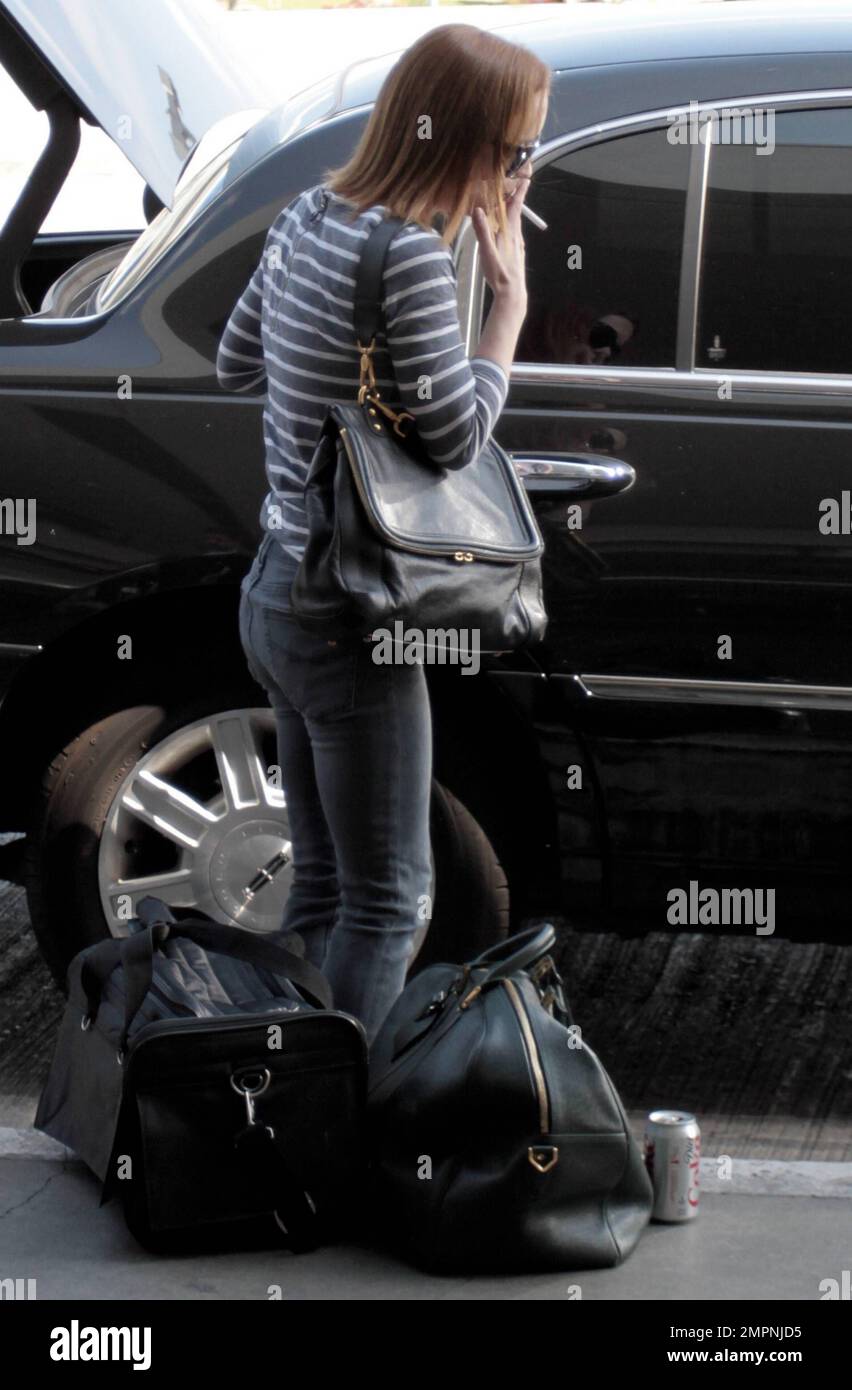 Actress Christina Ricci smoking a cigarette at LAX Airport before ...