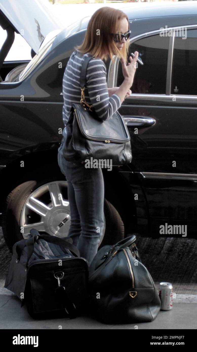 Actress Christina Ricci smoking a cigarette at LAX Airport before ...