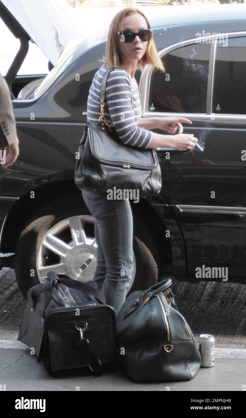 Actress Christina Ricci smoking a cigarette at LAX Airport before ...