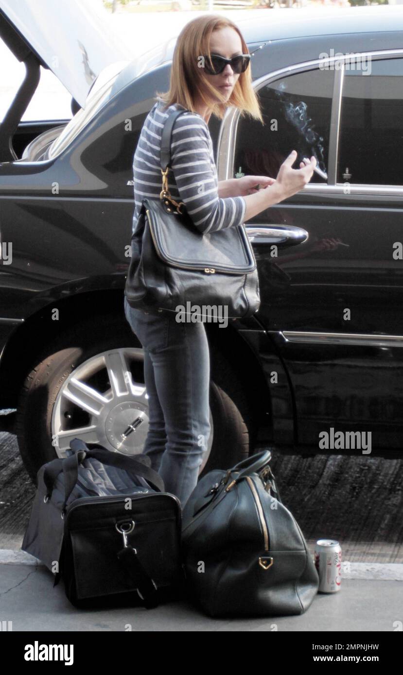 Actress Christina Ricci smoking a cigarette at LAX Airport before ...