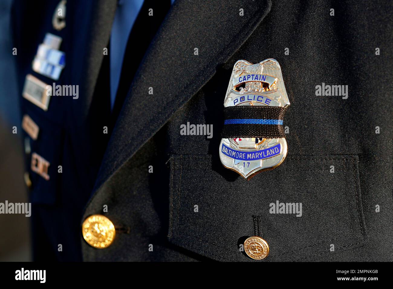 Baltimore Police Capt. Jarron Jackson wears a black mourning band ...