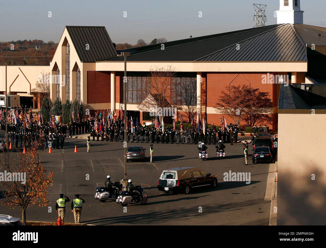 A hearse carrying Baltimore Police Det. Sean Suiter's body arrives for ...