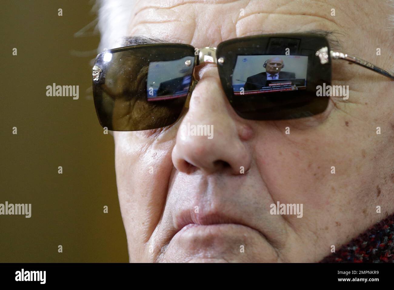 A Bosnian man watches the live TV broadcast from the International ...