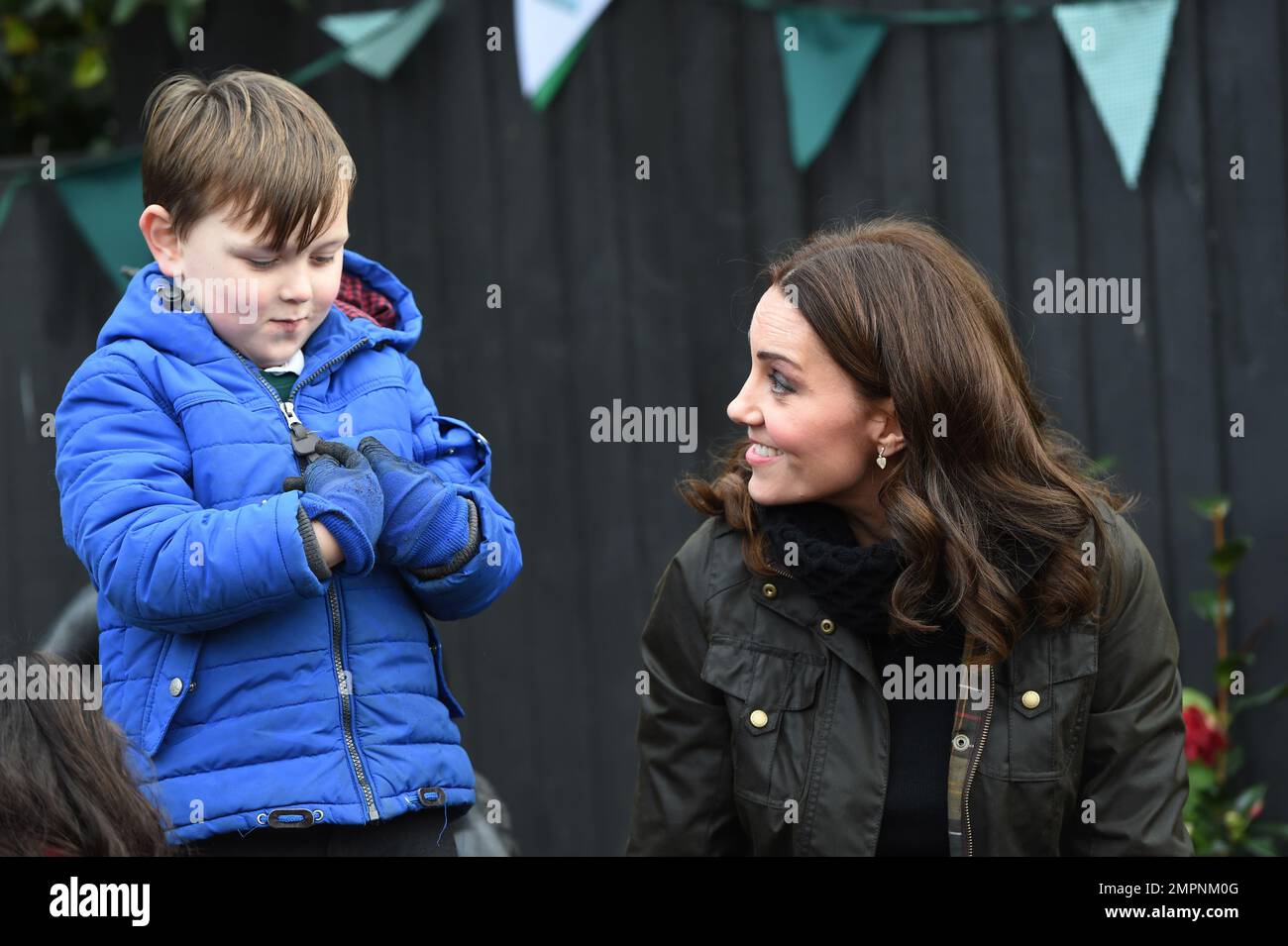 Britain's Kate, the Duchess of Cambridge, talks to a boy as she visits ...