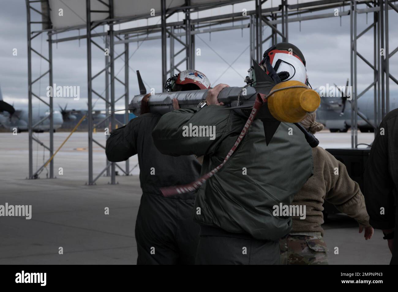U.S. Marines from across 3rd Marine Aircraft Wing carry an AIM-9 ...