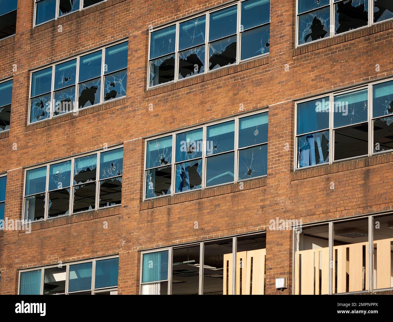 Office block glass windows smashed by vandals in Manchester UK Stock ...