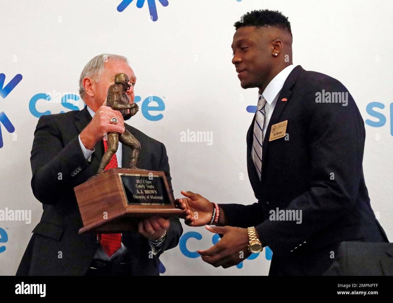 Mississippi wide receiver A.J. Brown, right, is handed the Conerly ...