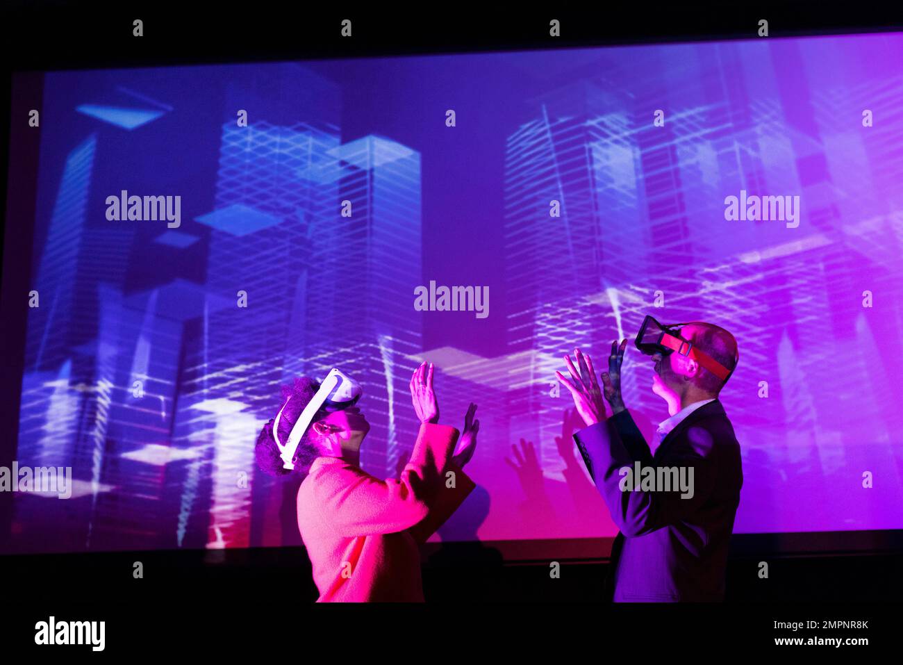 Business colleagues with futuristic glasses gesturing by projection ...