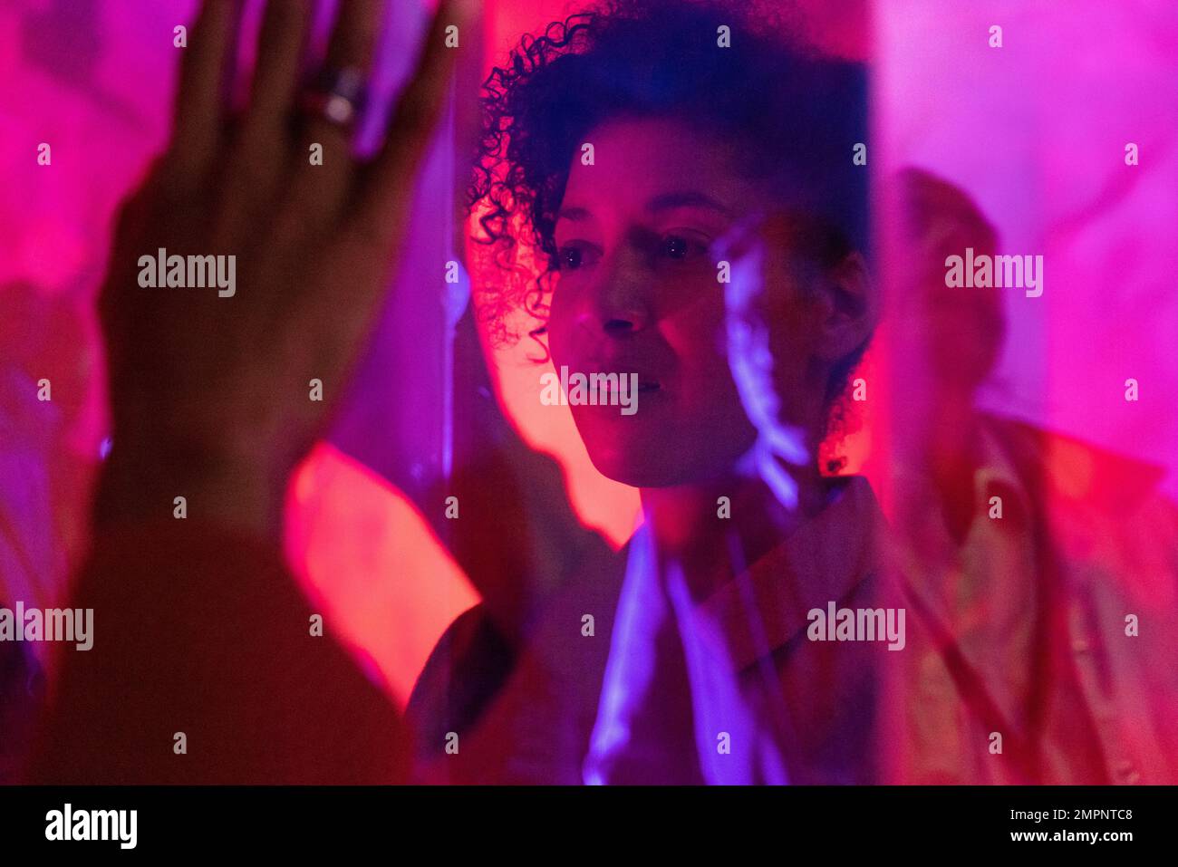 Female entrepreneur examining glass display during corporate event at ...