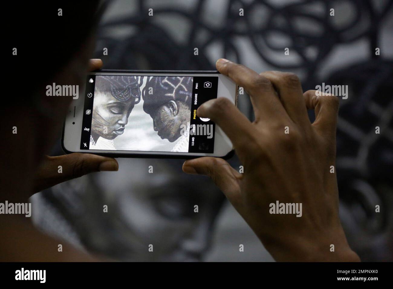 In this photo taken Friday, Nov. 10, 2017, a woman takes a photo of the ...