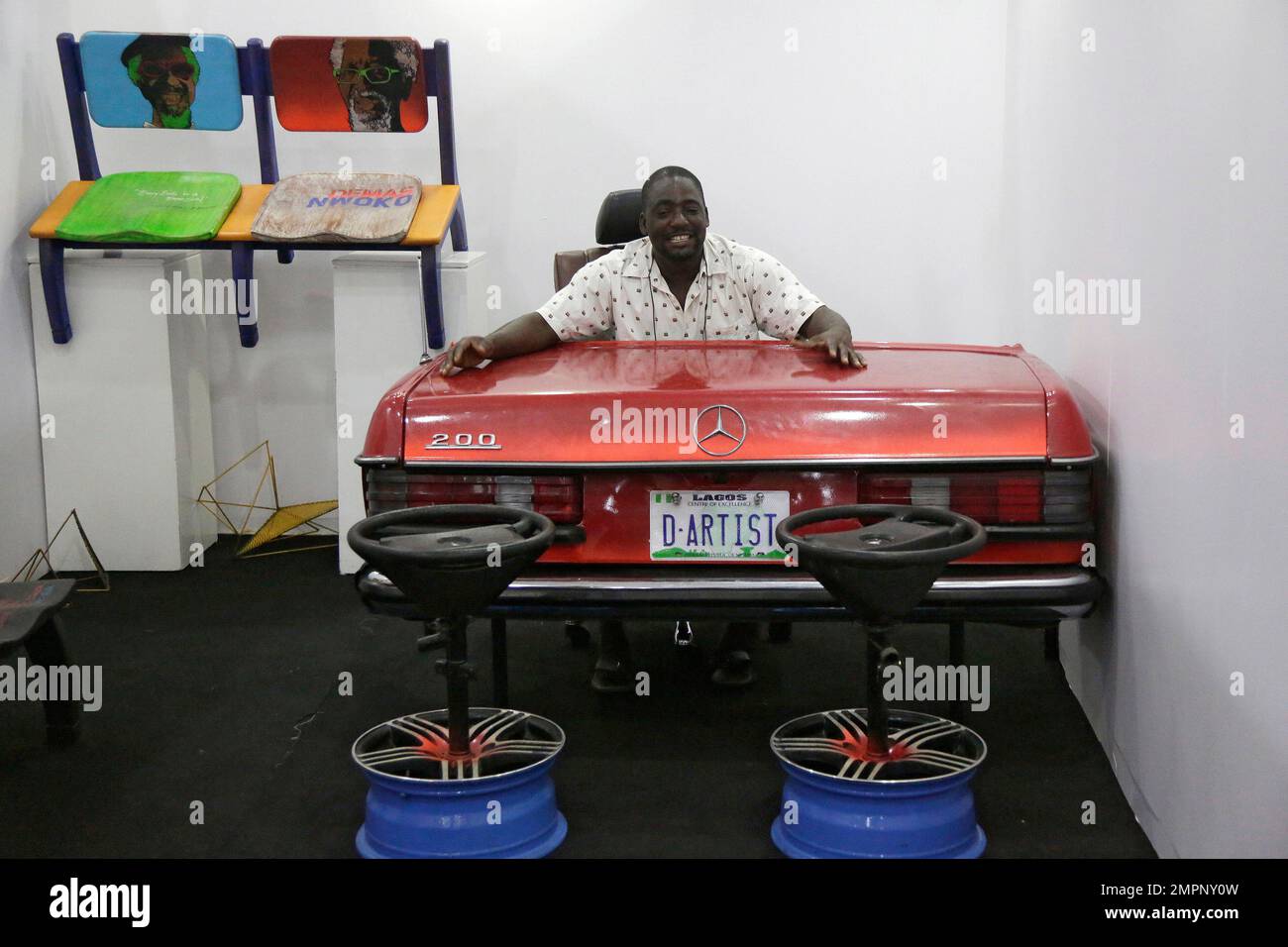 In this photo taken Friday, Nov. 10, 2017, a man sits on an art work ...