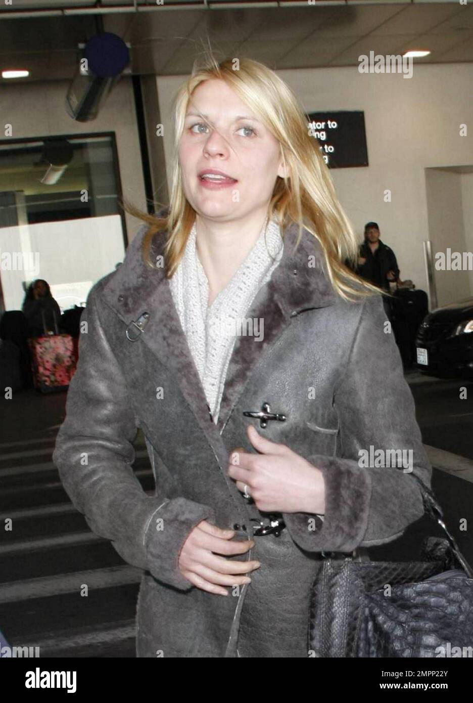 Dressed in a winter coat and boots actress Claire Danes arrives at LAX ...