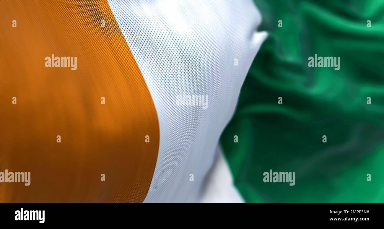 Detail of of Ivory Coast National flag waving. Orange, white, green ...