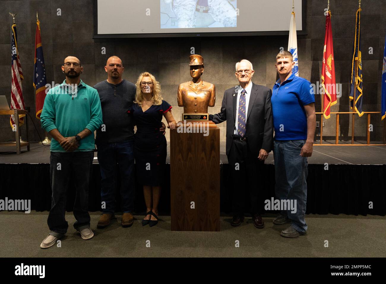 Ms. Paula Caruth, mother of Lance Cpl. Casey Casanova, stands next to a ...