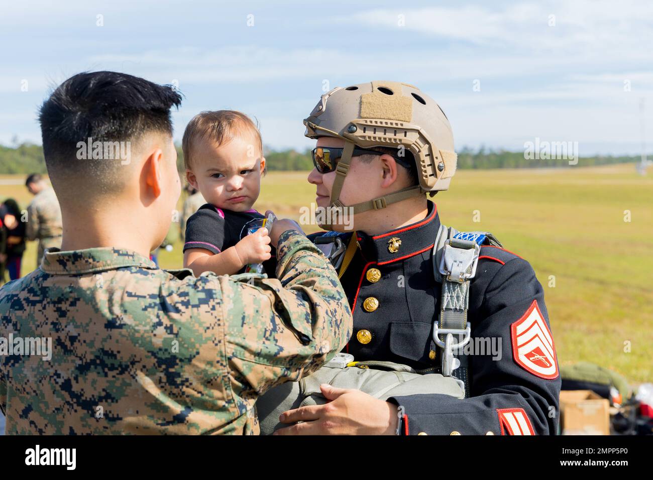 A U.S. Marine from the 3rd Reconnaissance Company holds his child at Camp Shelby Joint Forces ...
