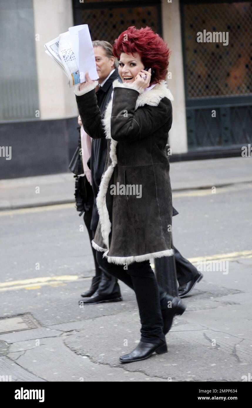 Wearing a shearling jacket and showing off her fire-engine red hair ...