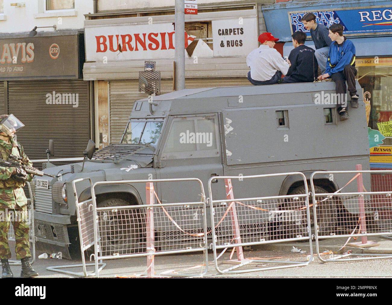 An Army patrol in Belfast's Shankill Road with youngsters sitting atop ...