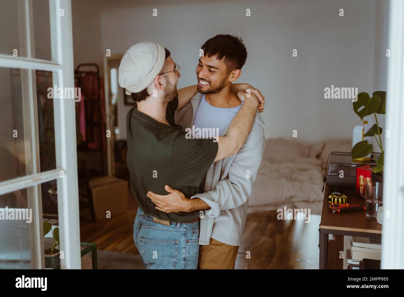 Romantic man talking with boyfriend in bedroom at home Stock Photo - Alamy