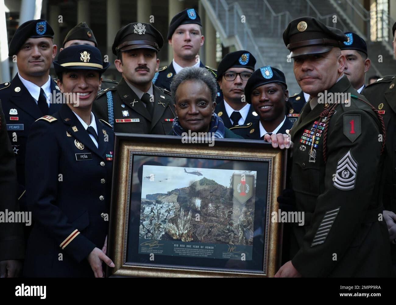 Acting 1st Infantry Division Command Sgt. Maj. Albert Serrano presents ...