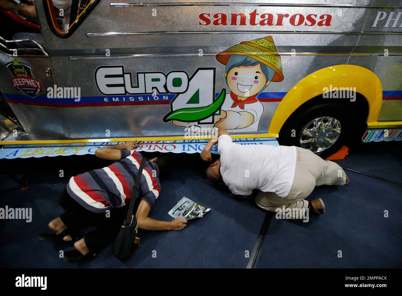 In this Oct. 12, 2017, photo, Filipino drivers check the chasis of a ...