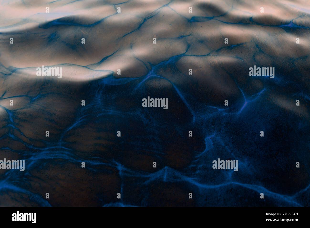 Abstract photo of a glowing water surface with dark blue light ...