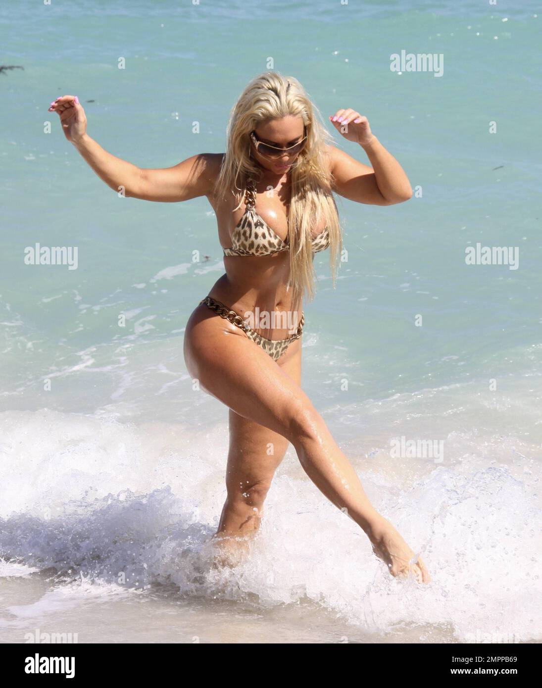 Coco shows off her enviable curves in an animal print bikini. The reality star took to the water ...