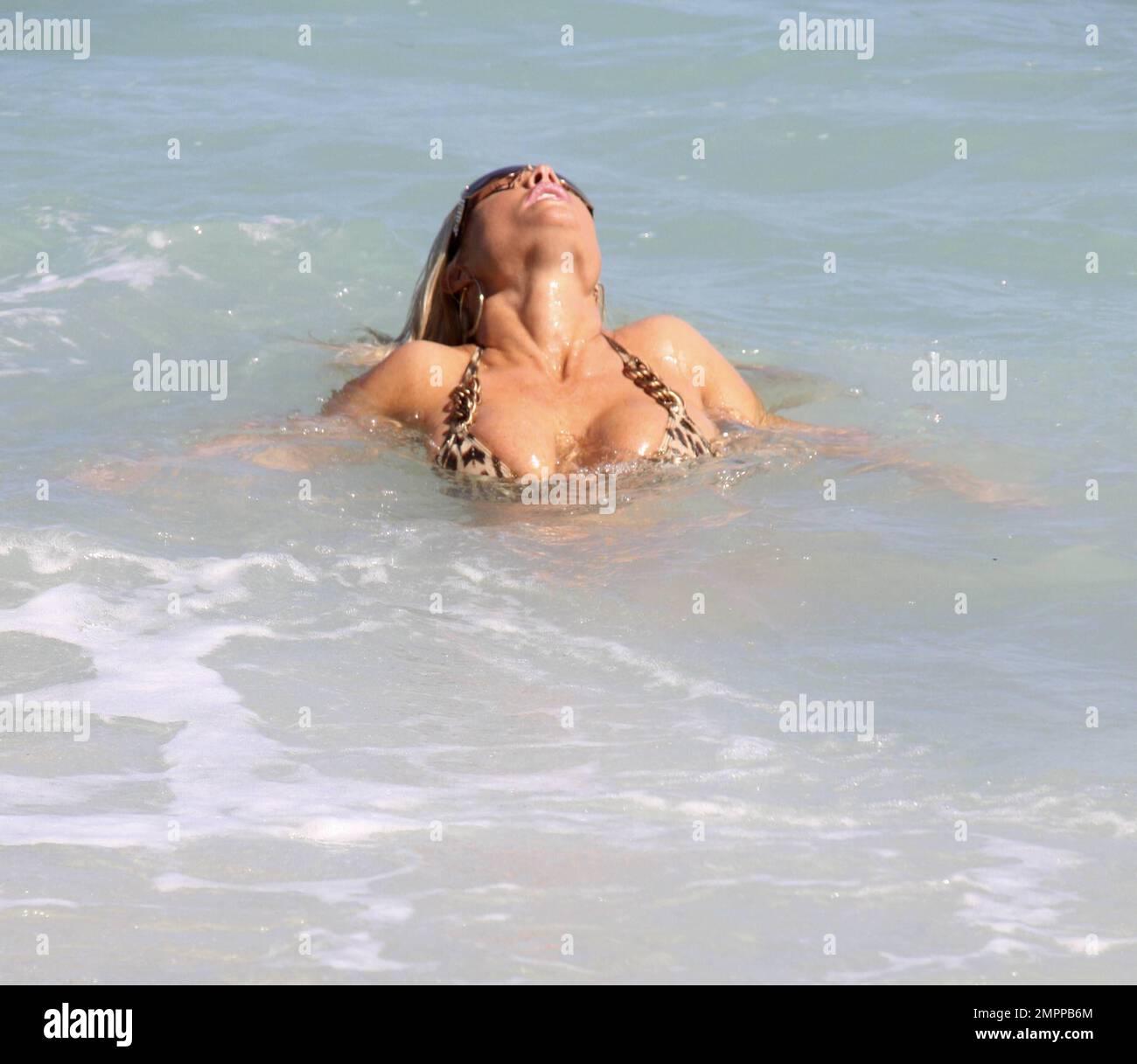 Coco shows off her enviable curves in an animal print bikini. The reality star took to the water ...