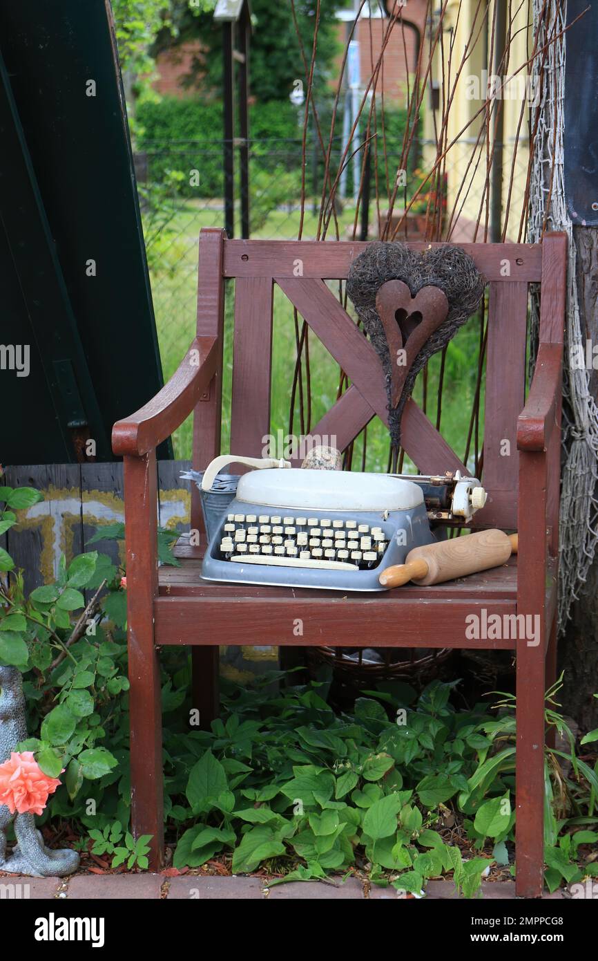 Old wooden chair with typewriter, metal heart and rolling pin Stock ...