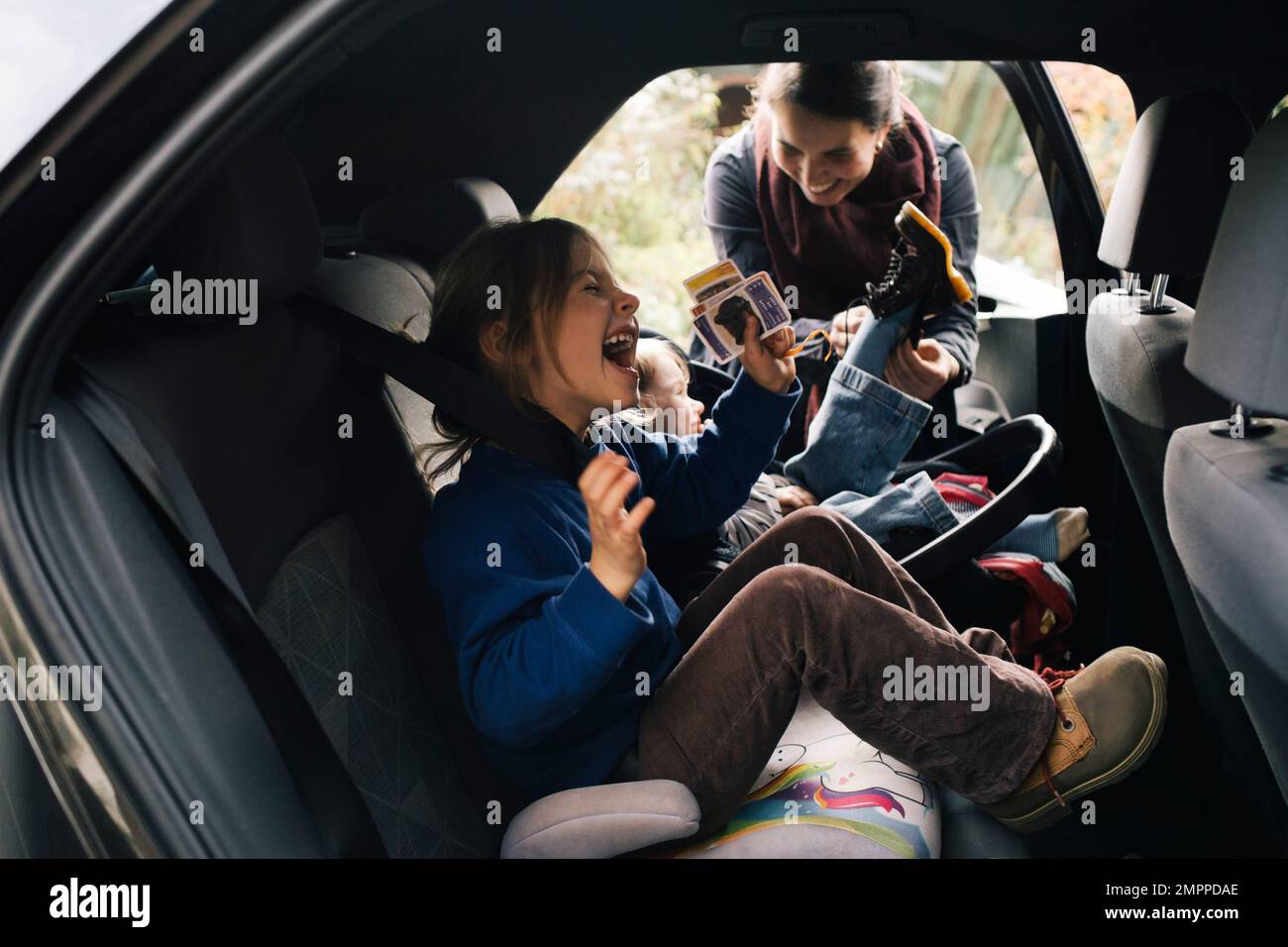 Side view of girl screaming while sitting at back seat of car Stock ...