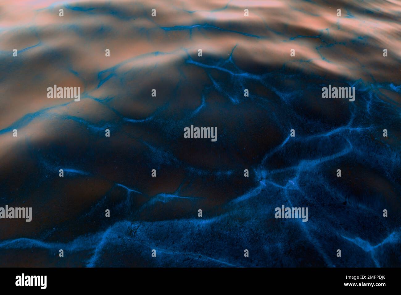 Abstract photo of a glowing water surface with dark blue neon light ...