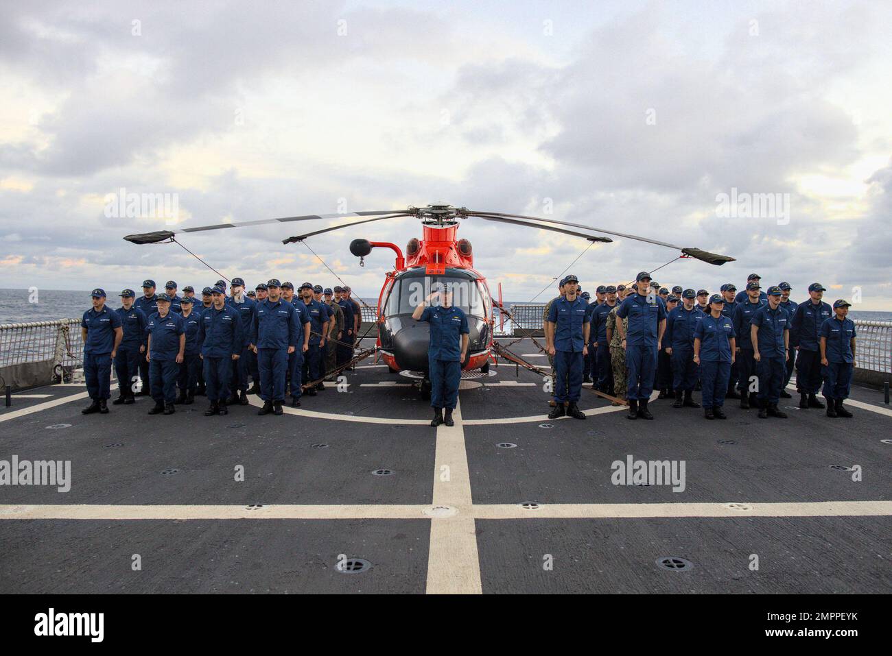 Capt. Timothy Brown, center, commanding officer of the U.S. Coast Guard ...