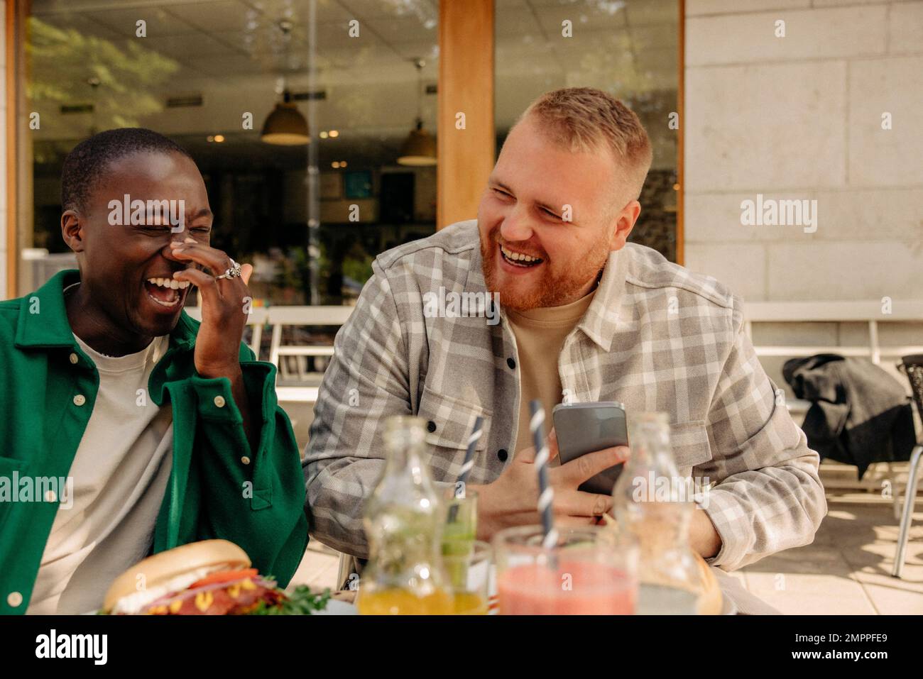 Two young men sitting cafe friends hi-res stock photography and images ...