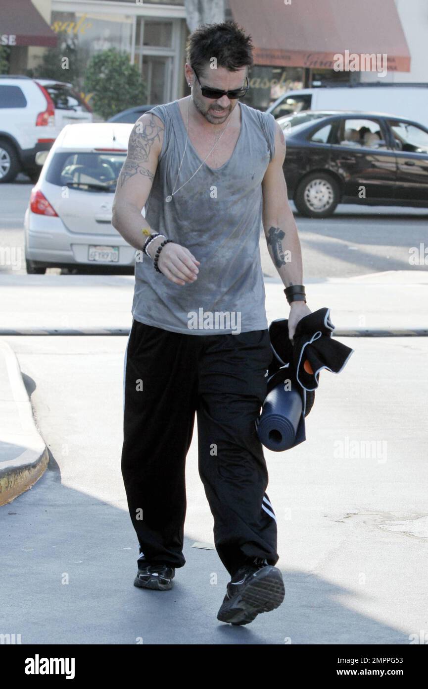Colin Farrell looks like a bad boy showing off his tattoos in a grey ...