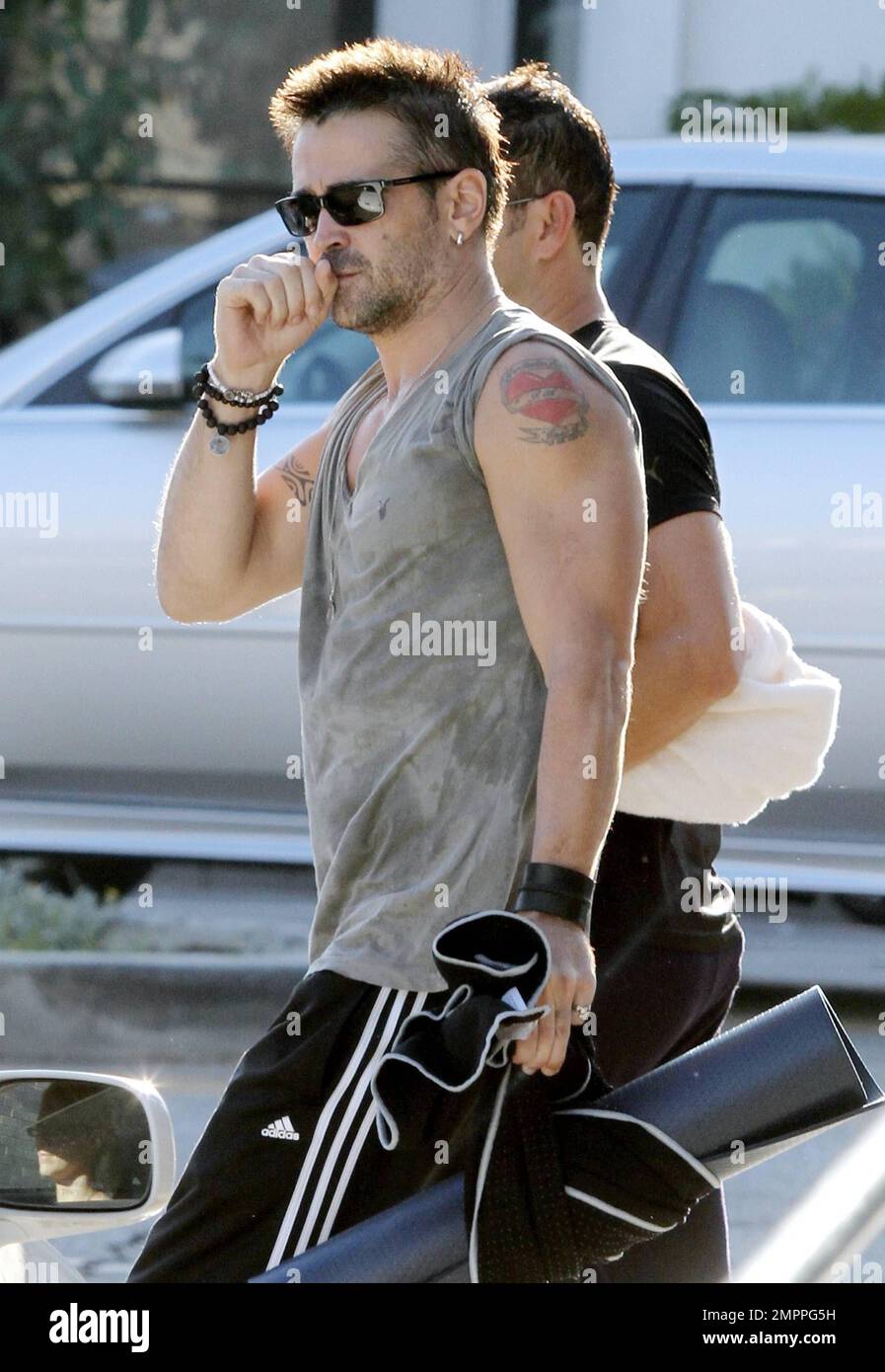 Colin Farrell looks like a bad boy showing off his tattoos in a grey ...