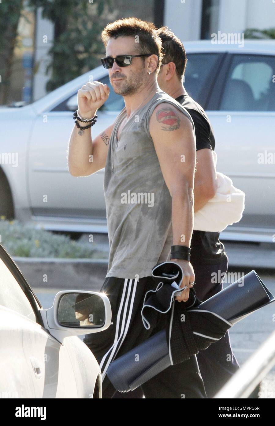 Colin Farrell looks like a bad boy showing off his tattoos in a grey ...