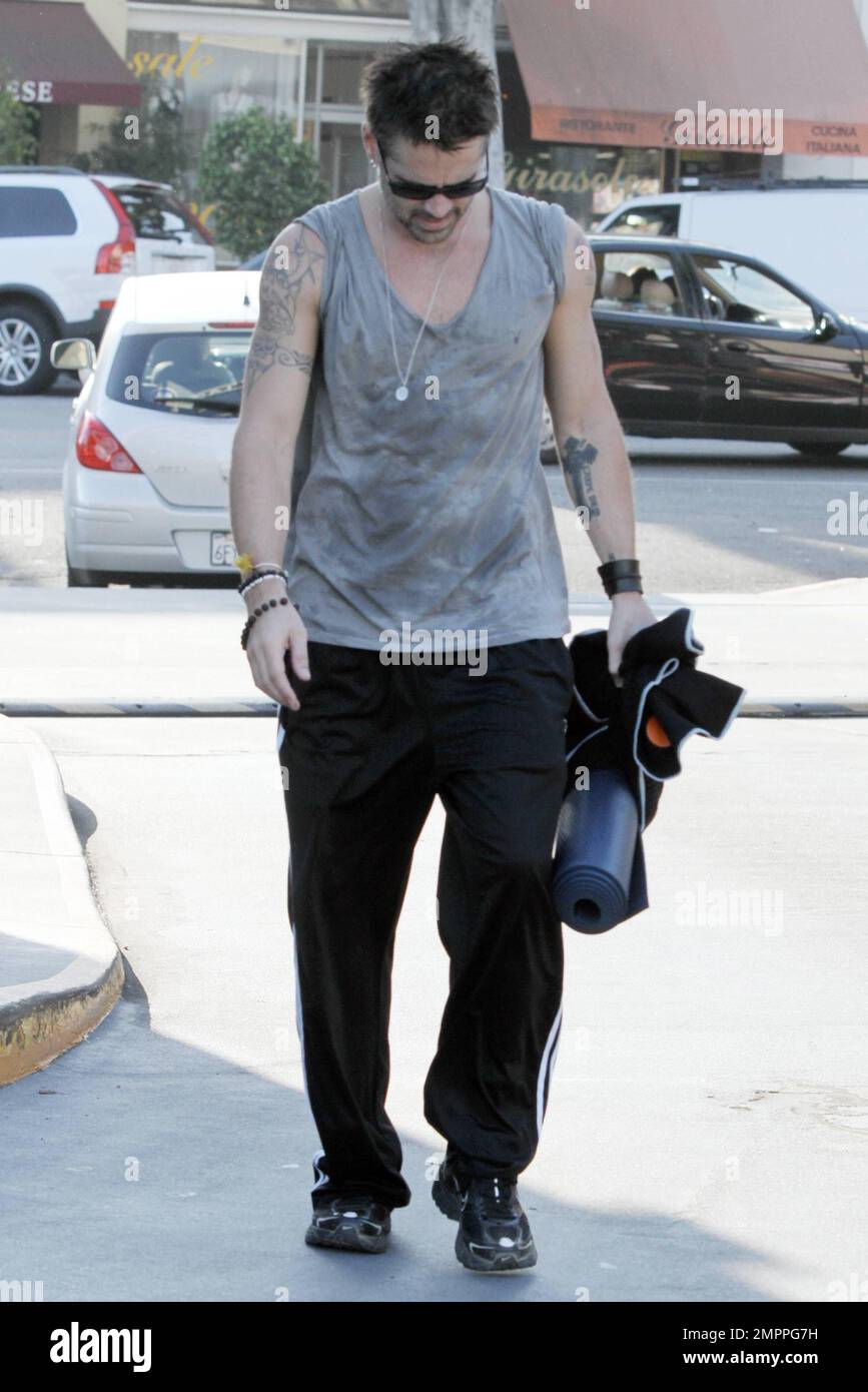 Colin Farrell looks like a bad boy showing off his tattoos in a grey ...