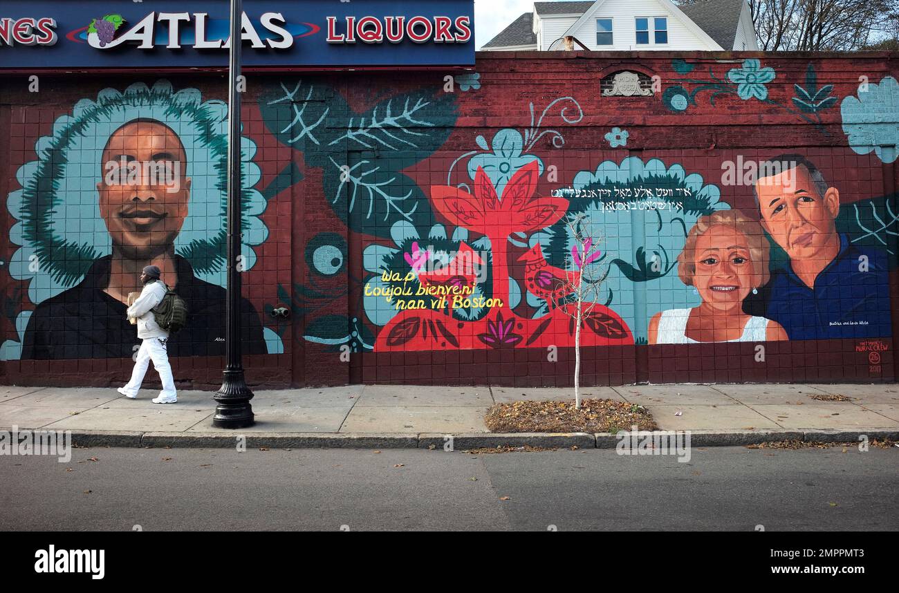 In this Monday, Nov. 20, 2017 photo a passerby walks past a mural that ...