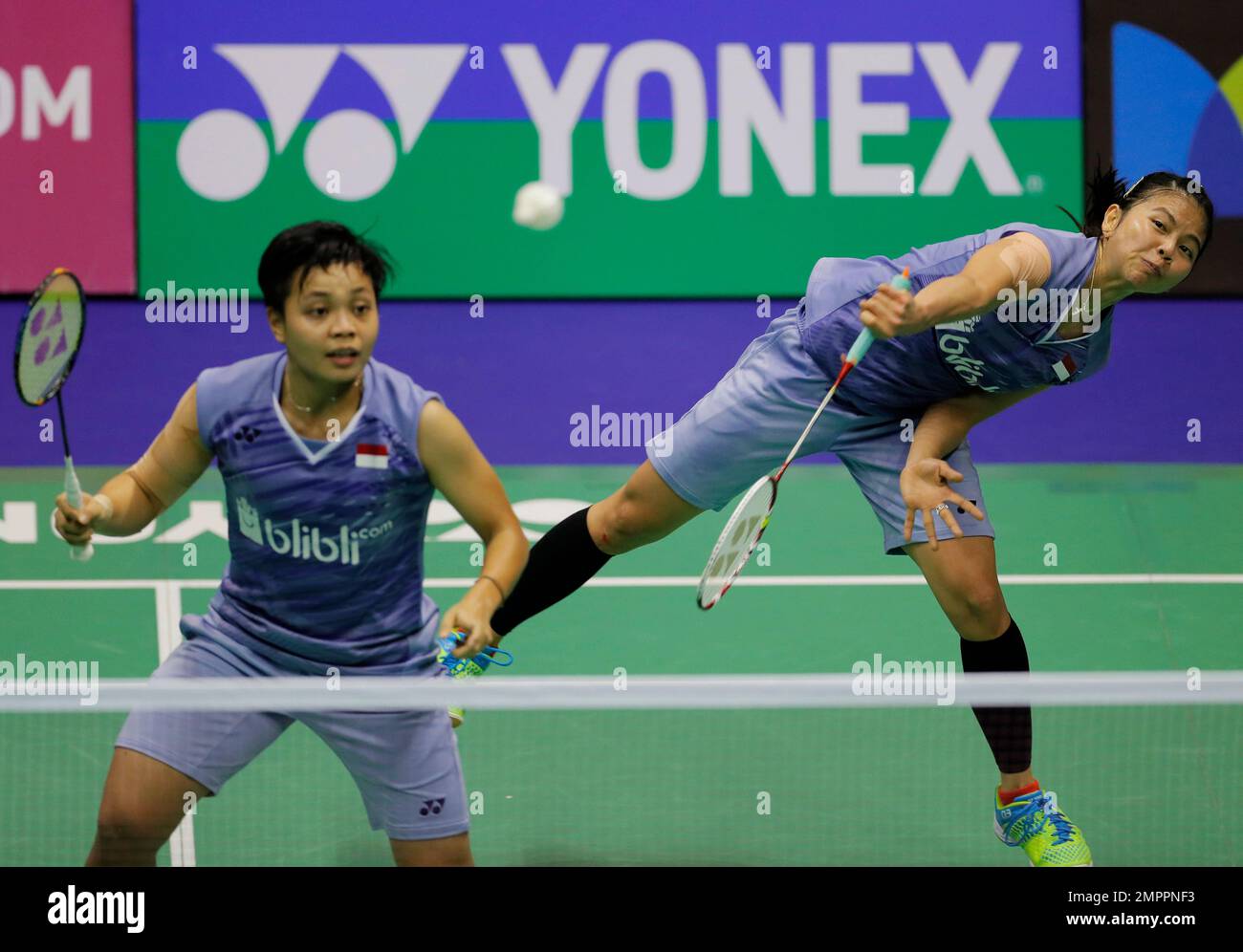 Greysia Polii, right, and Apriyani Rahayu return a shot against Chen Qingchen and Jia Yifan of ...
