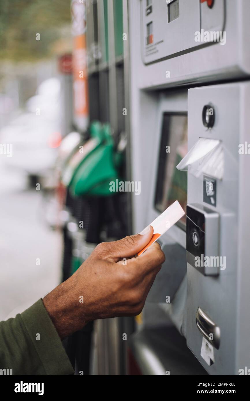 Man holding credit card while doing payment at fuel station Stock Photo ...