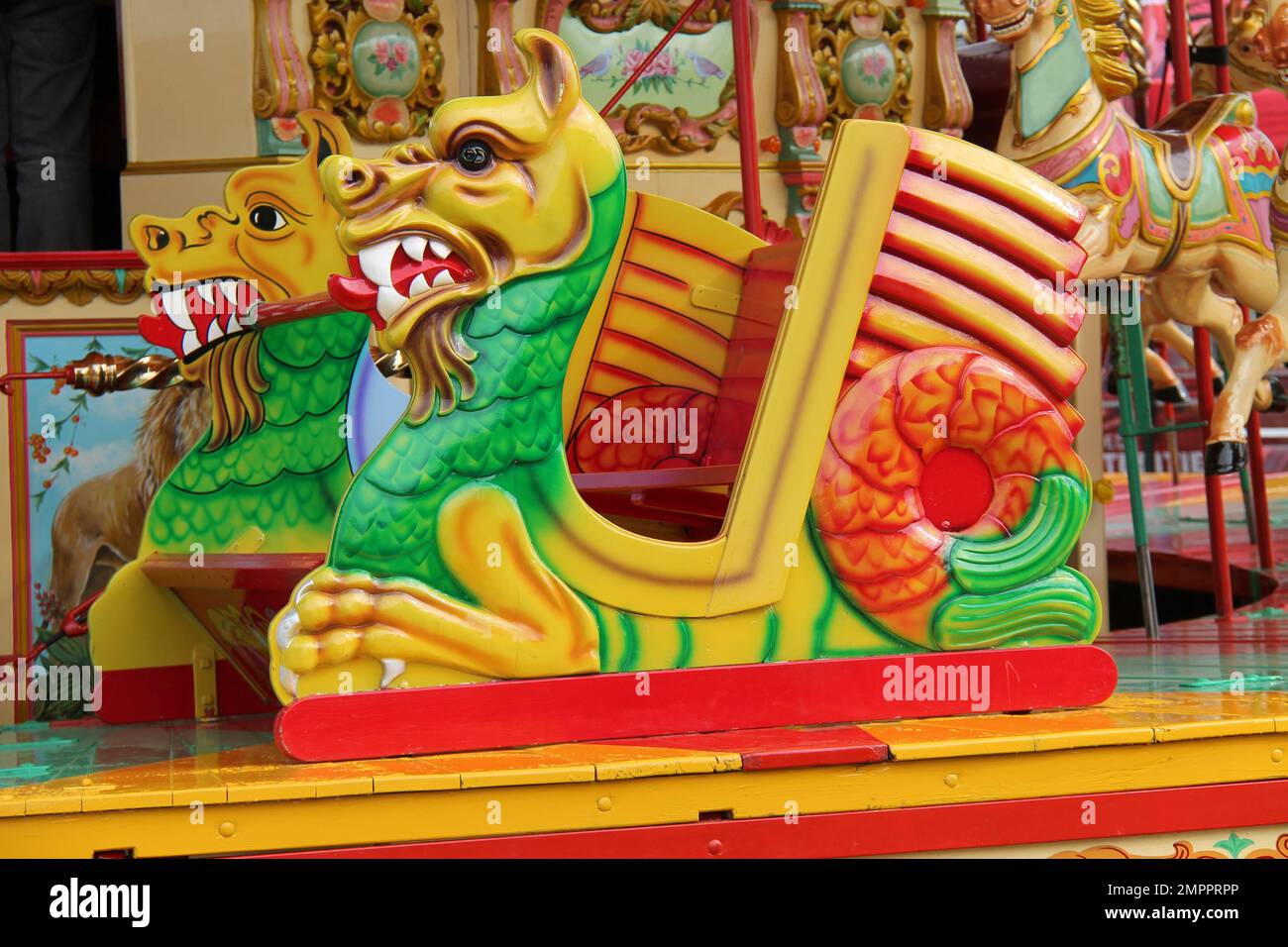 Wooden Dragon Seats on a Fun Fair Amusement Ride Stock Photo - Alamy
