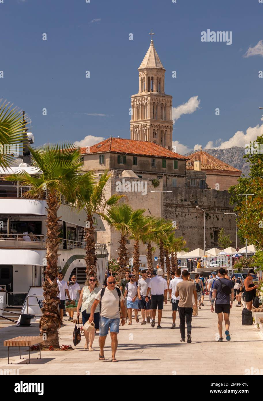 SPLIT, CROATIA, EUROPE - Tourists walk along waterfront. In distance is ...