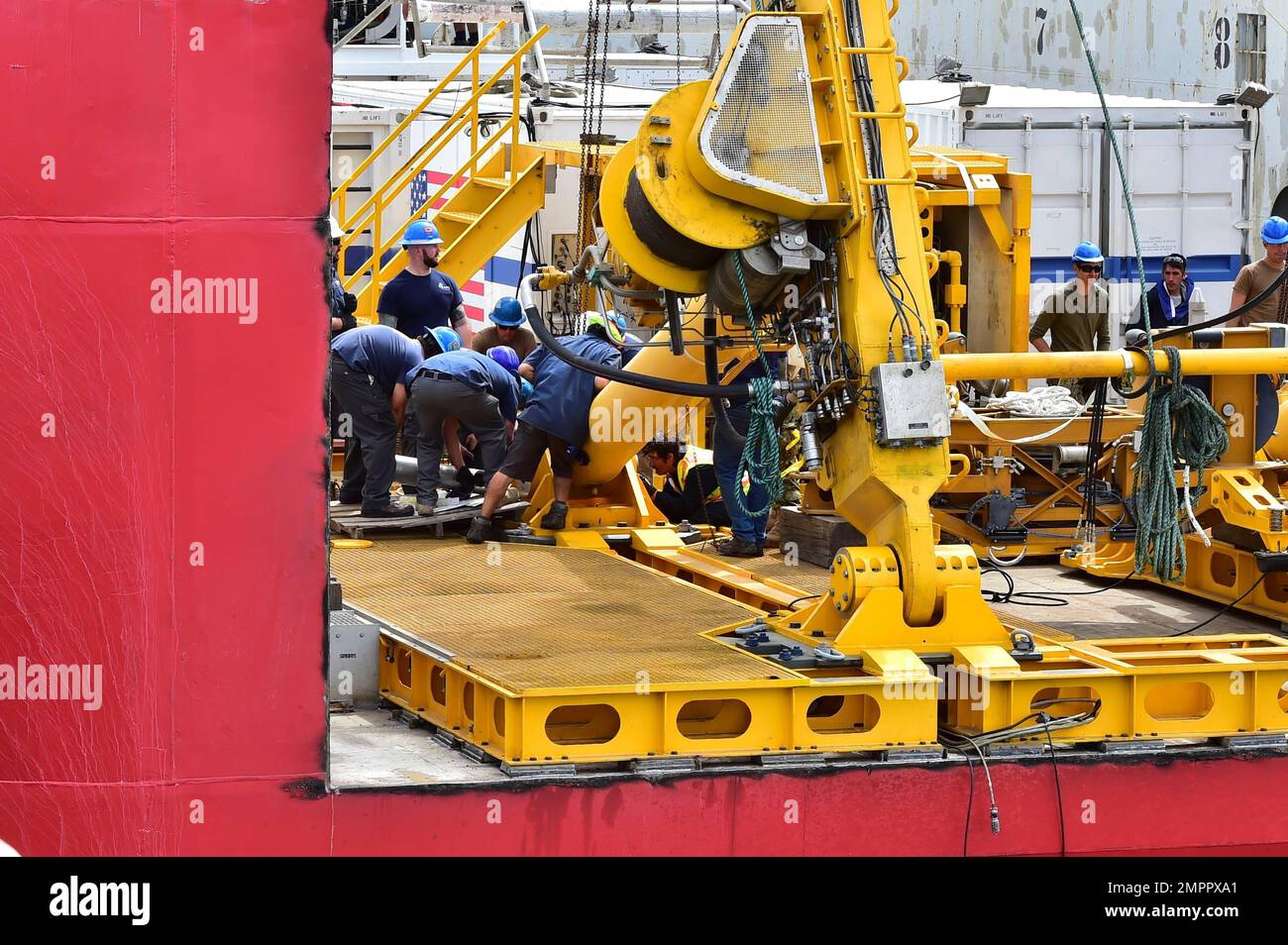 Workers install a crane in the Sophie Siem ship in Comodoro Rivadavia ...