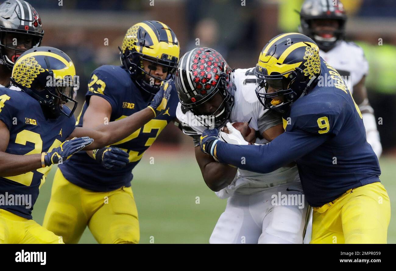 Ohio State quarterback J.T. Barrett (16) is stopped by Michigan ...