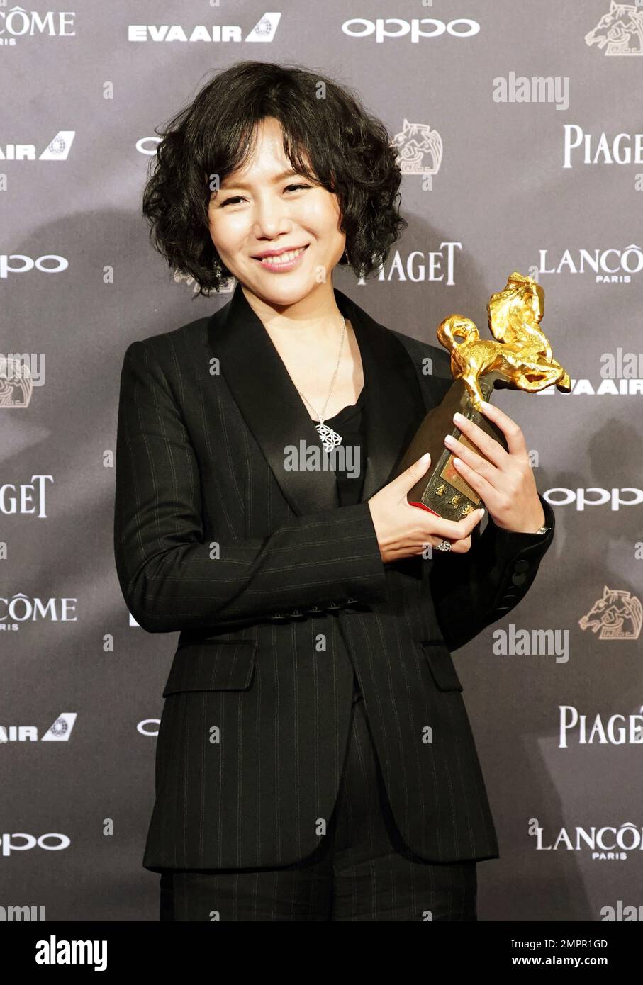 Chinese director Vivian Qu holds her awards and poses for media for ...
