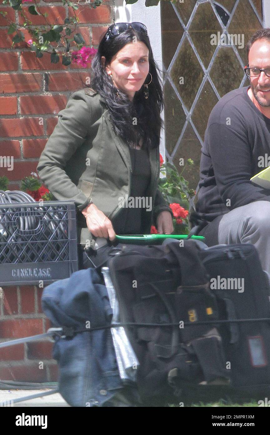Courteney Cox looks to be wearing no makeup as she works on her script ...