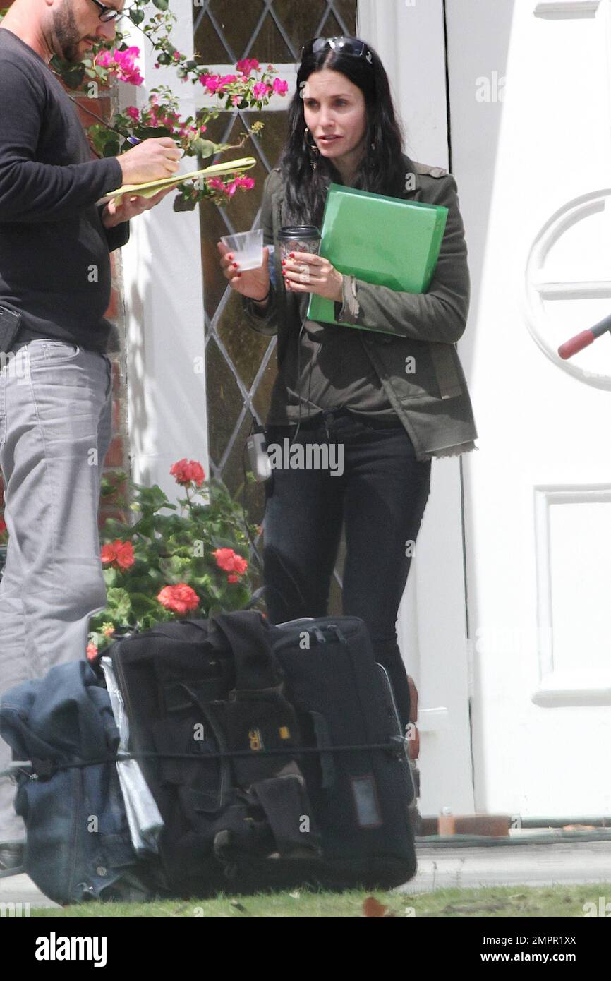 Courteney Cox looks to be wearing no makeup as she works on her script ...