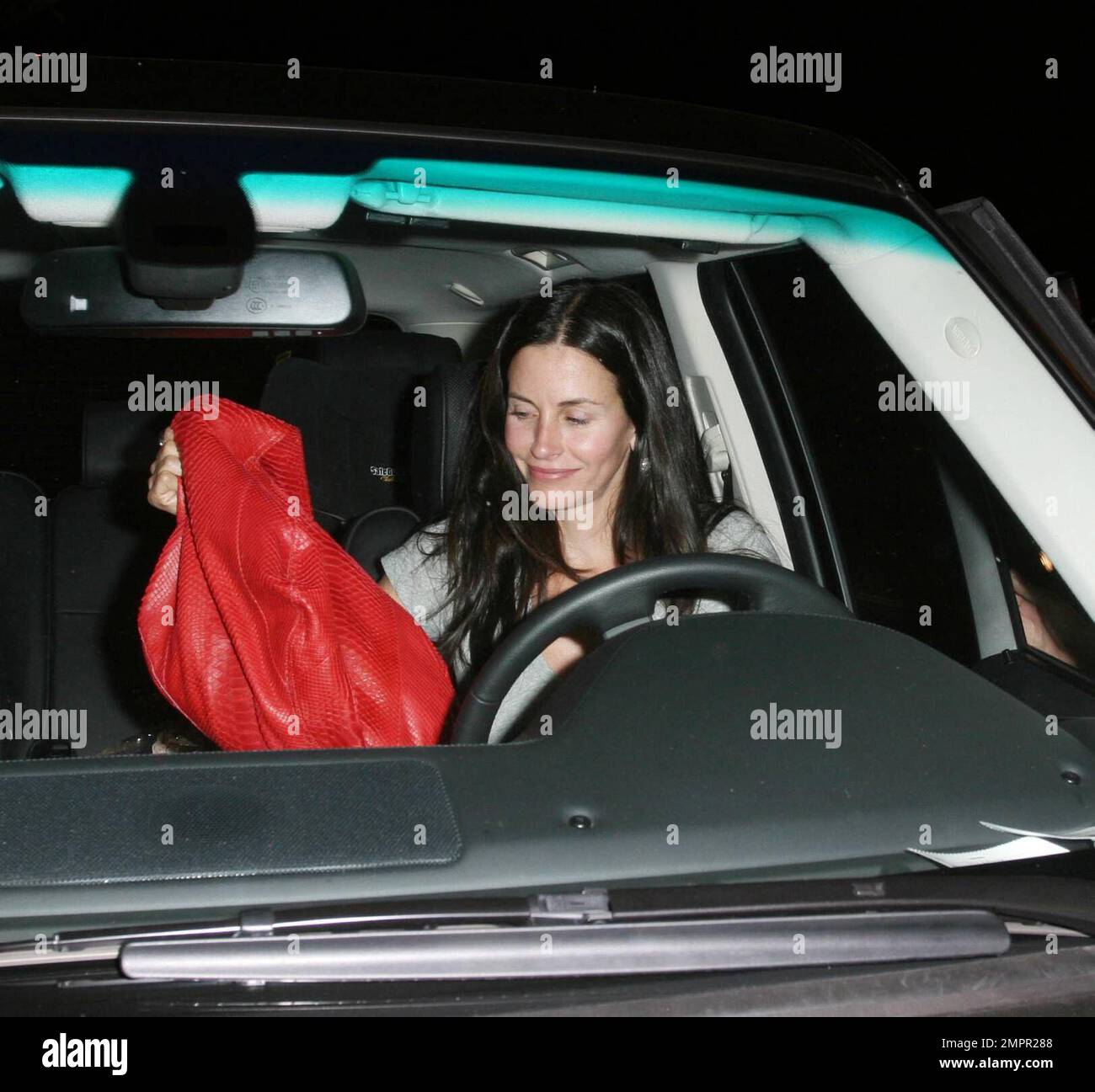 Courteney Cox smiles for photographers as she leaves one of her ...